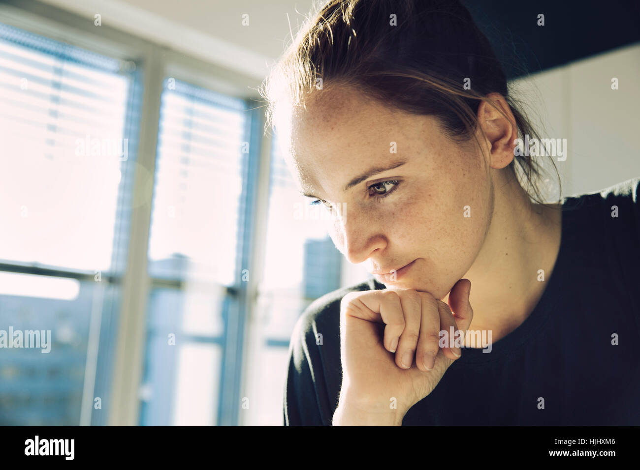 Pensive young woman Stock Photo - Alamy
