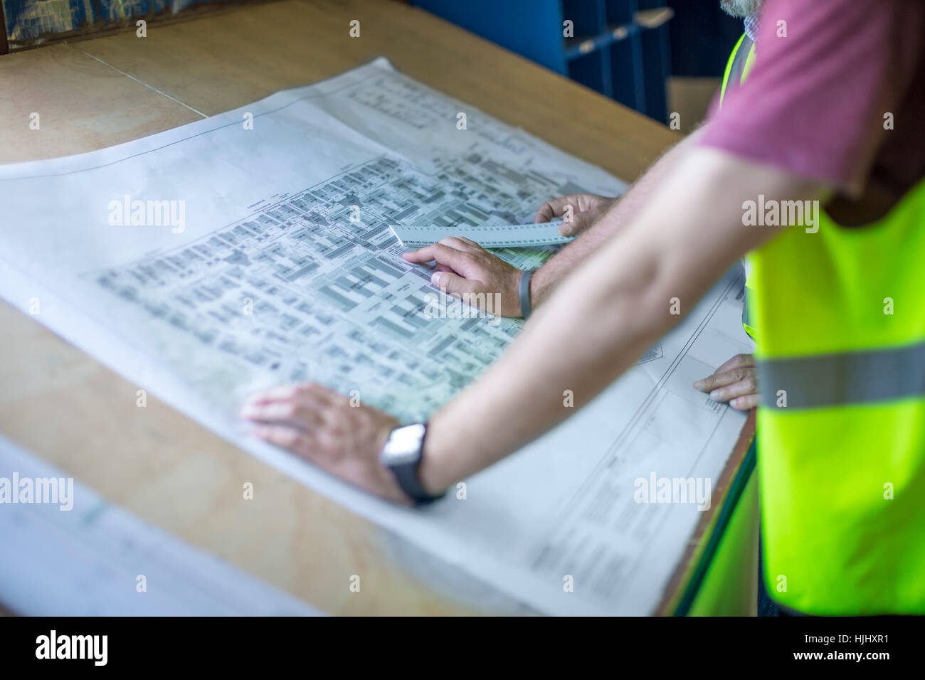 Engineers looking at blueprints in site office Stock Photo - Alamy
