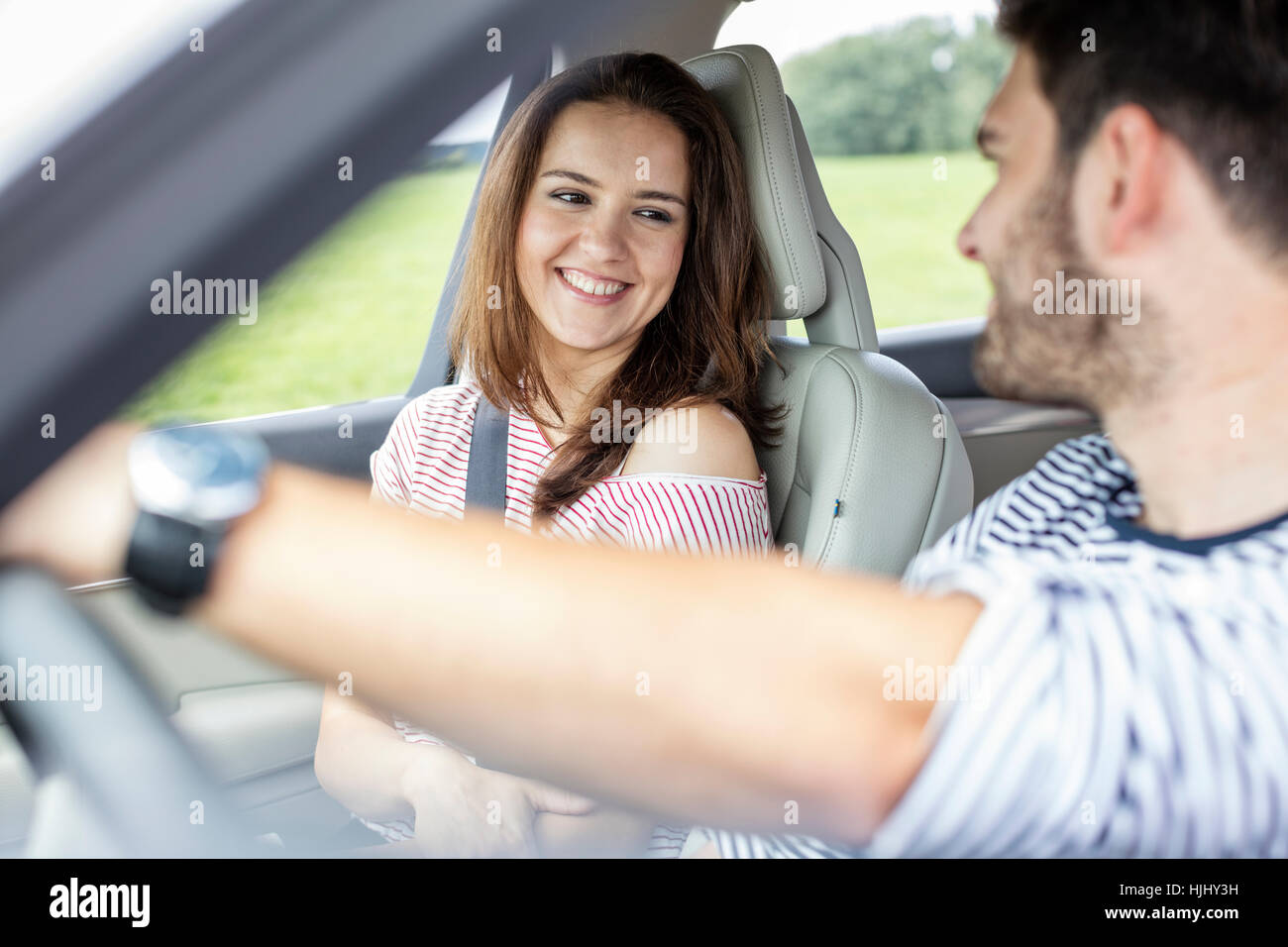 Couple driving in car Stock Photo - Alamy