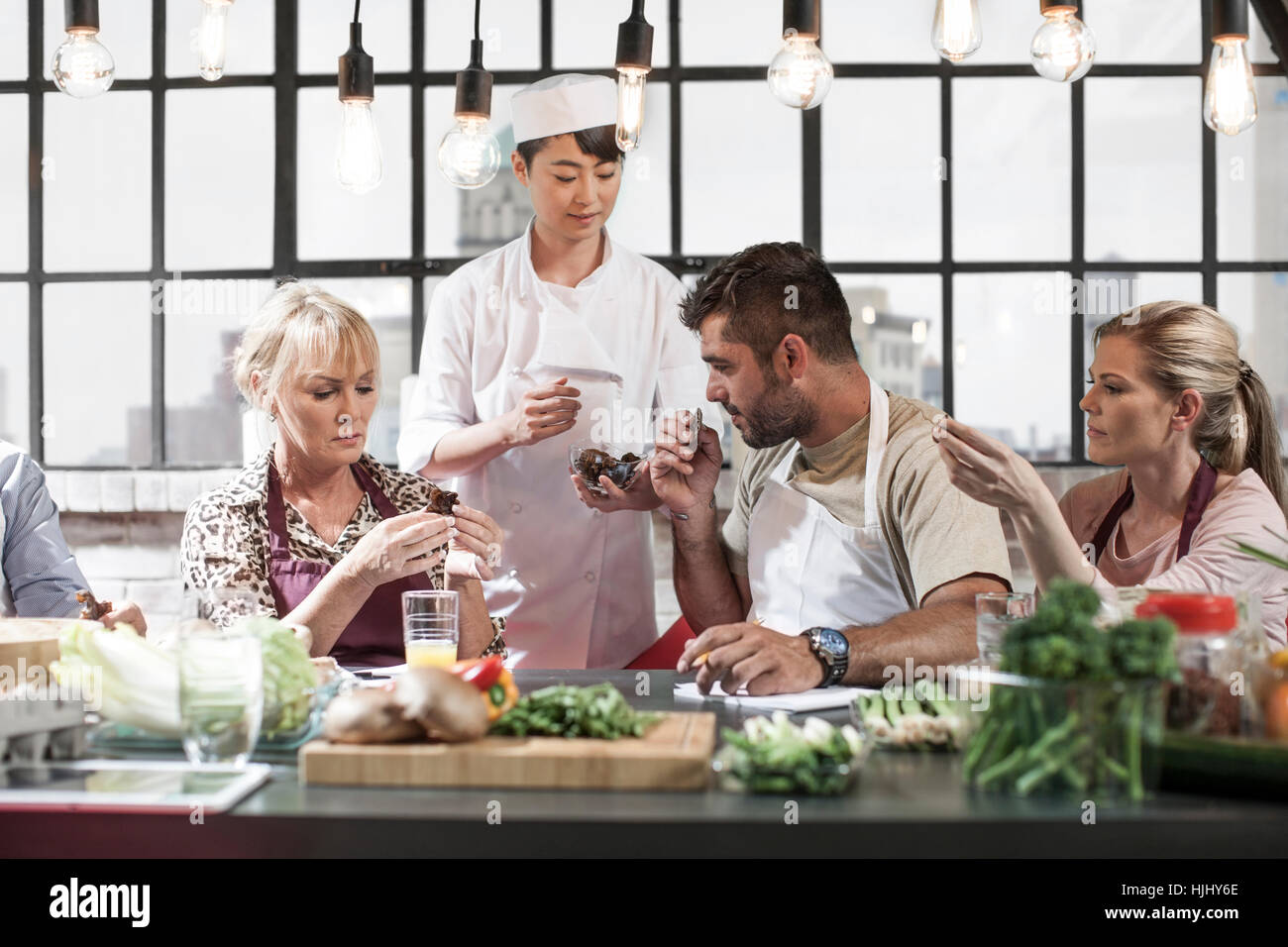 Group of people taking cooking course Stock Photo - Alamy