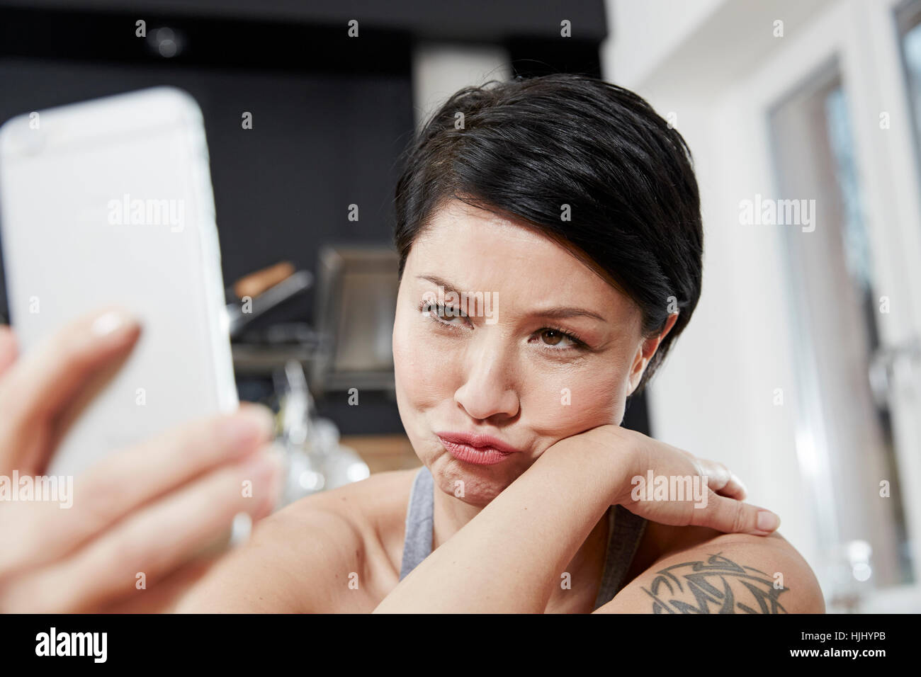 Woman taking a selfie pouting Stock Photo - Alamy