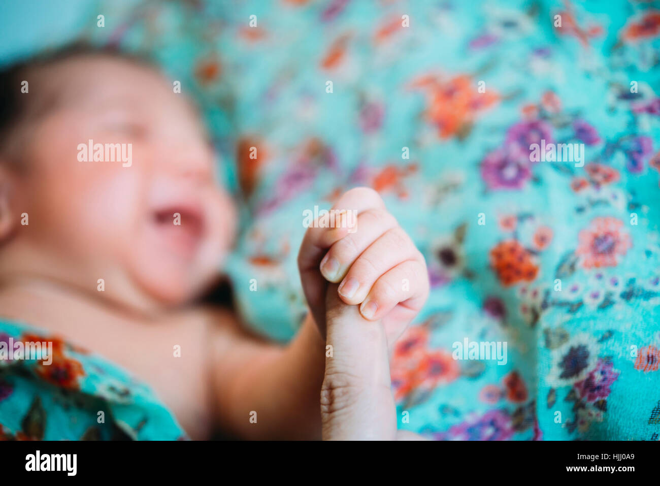 Baby gripping finger hi-res stock photography and images - Alamy
