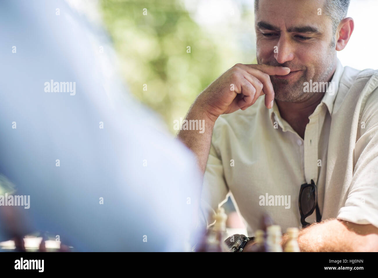 Man playing game of chess thinking Stock Photo - Alamy