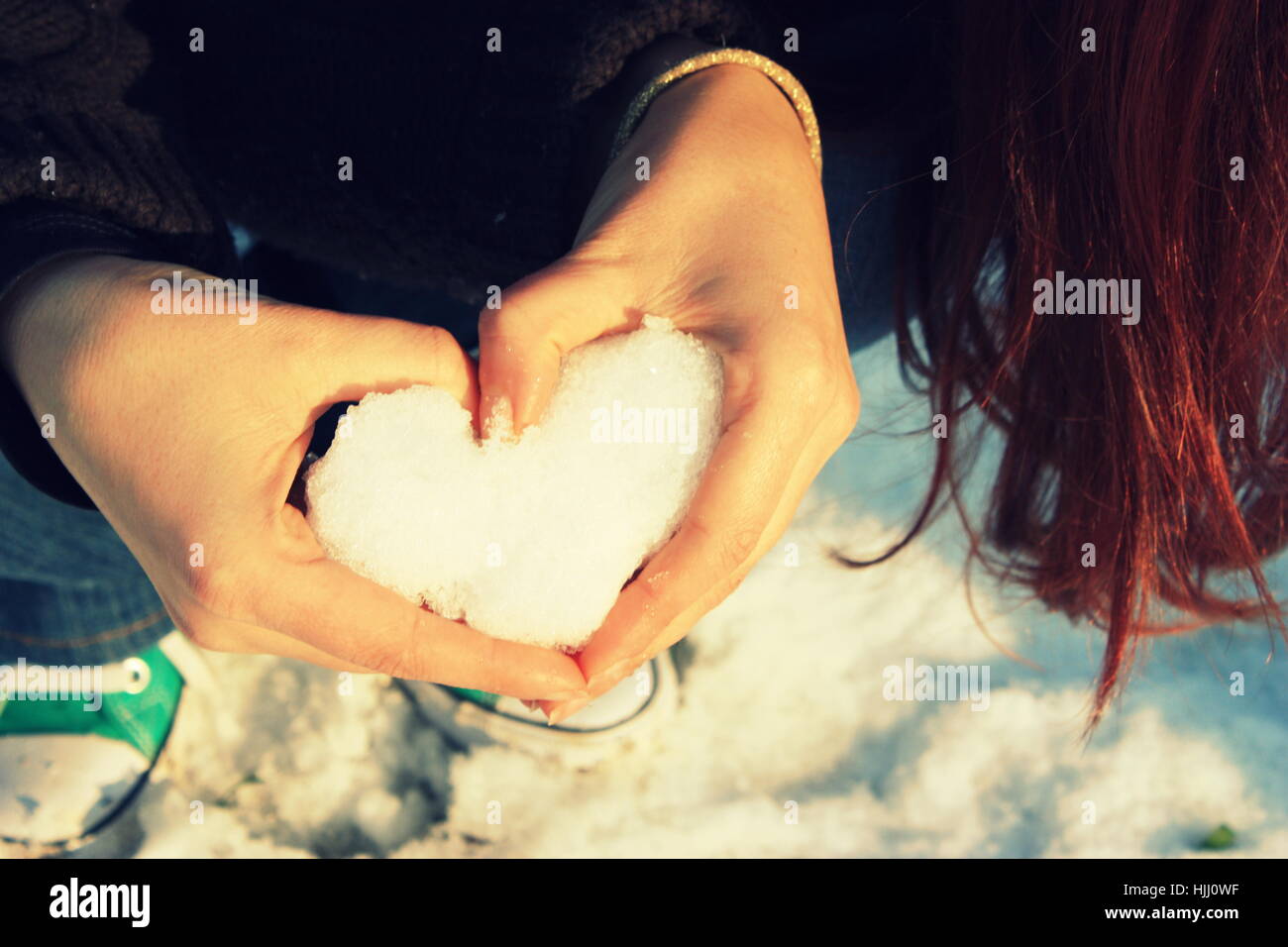 Heart Shape Hands filled with Snow Stock Photo - Alamy