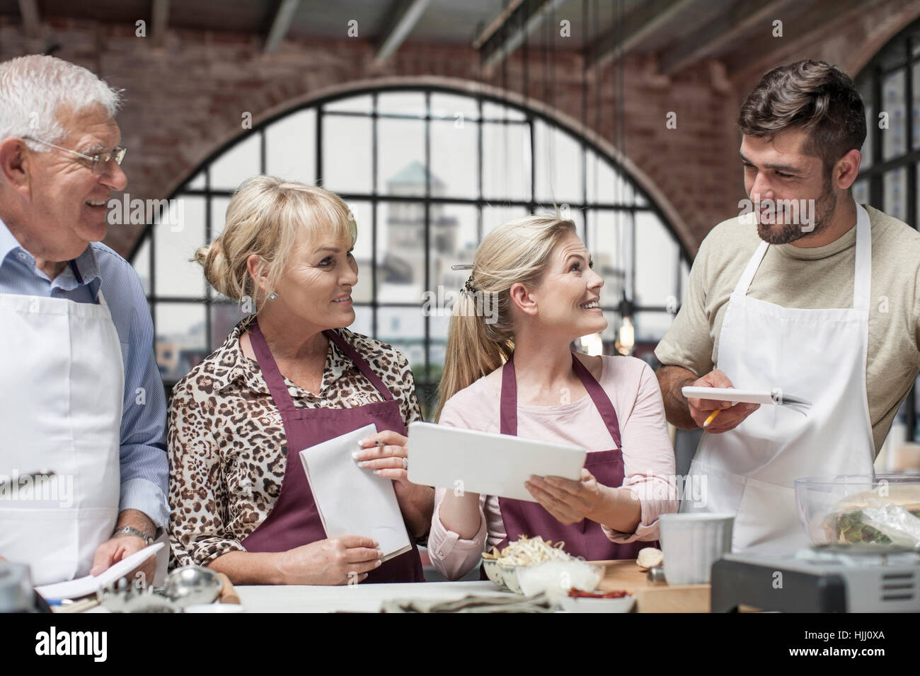 Group of people taking cooking course Stock Photo - Alamy