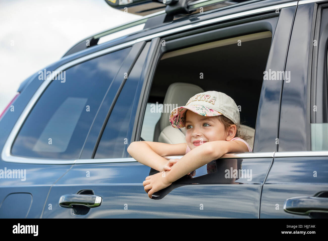 Girl sitting in car, looking out of window Stock Photo - Alamy