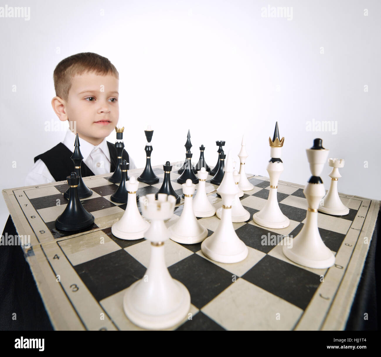 little boy playing chess on white Stock Photo - Alamy