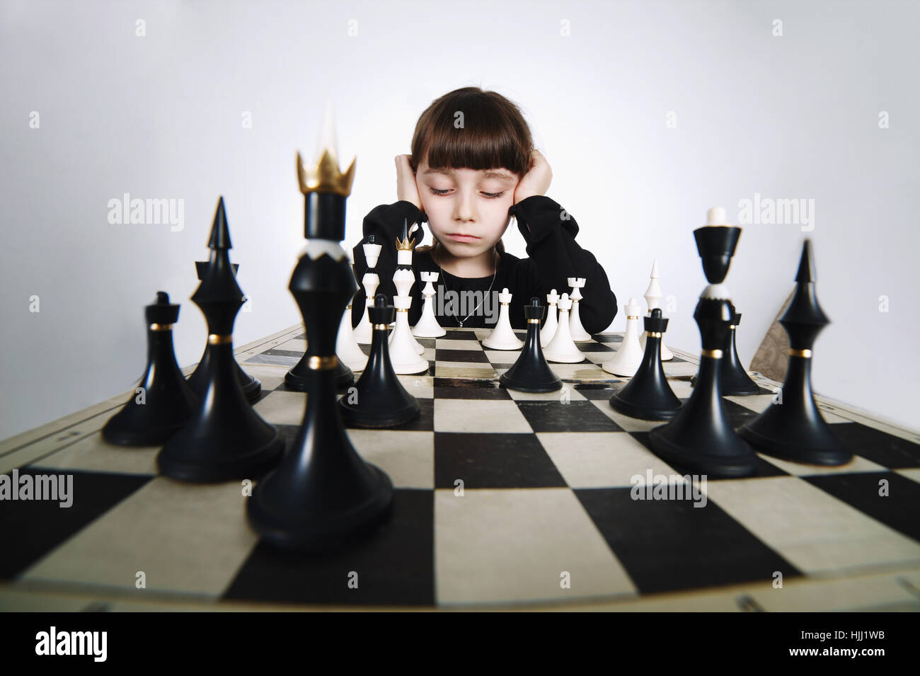 little girl playing chess on white Stock Photo - Alamy