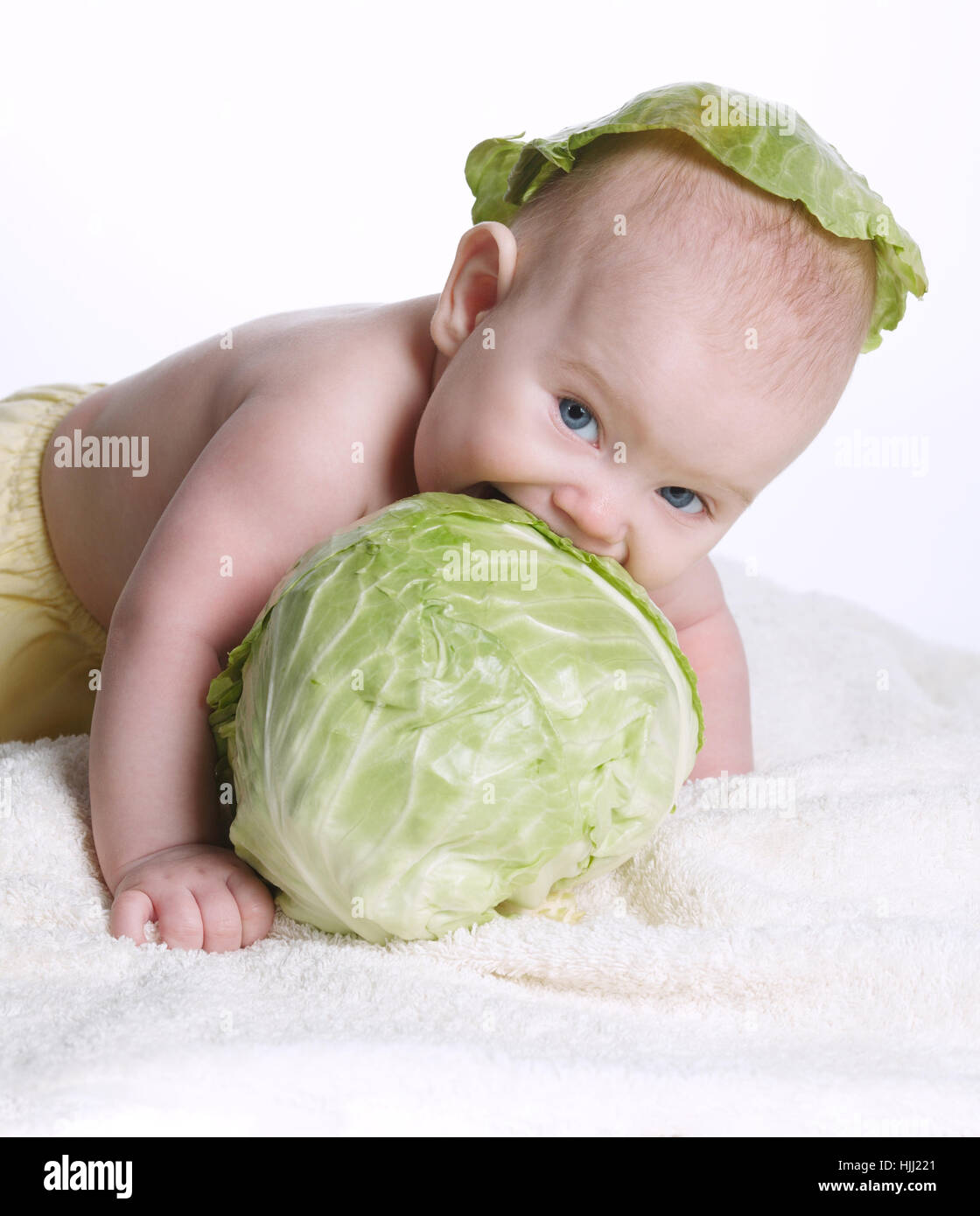 baby with cabbage leaf on his head Stock Photo - Alamy