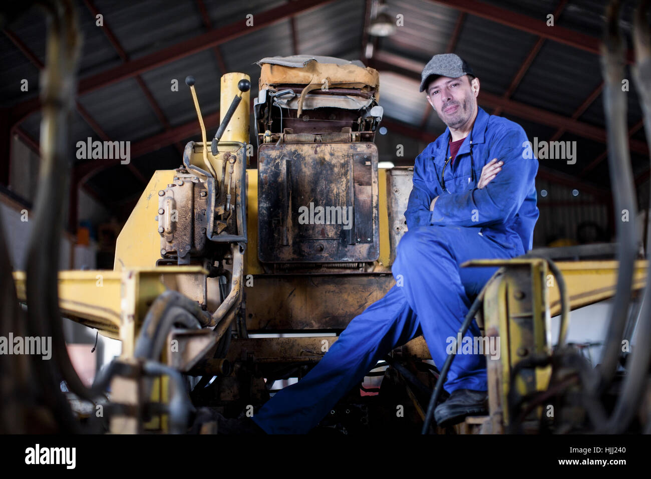 Man wearing blue overalls hi-res stock photography and images - Alamy