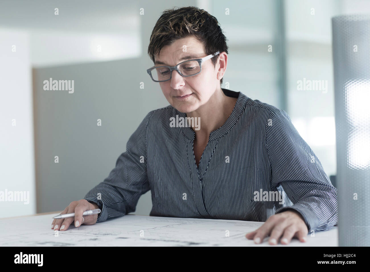Mature woman working at desk in office Stock Photo - Alamy