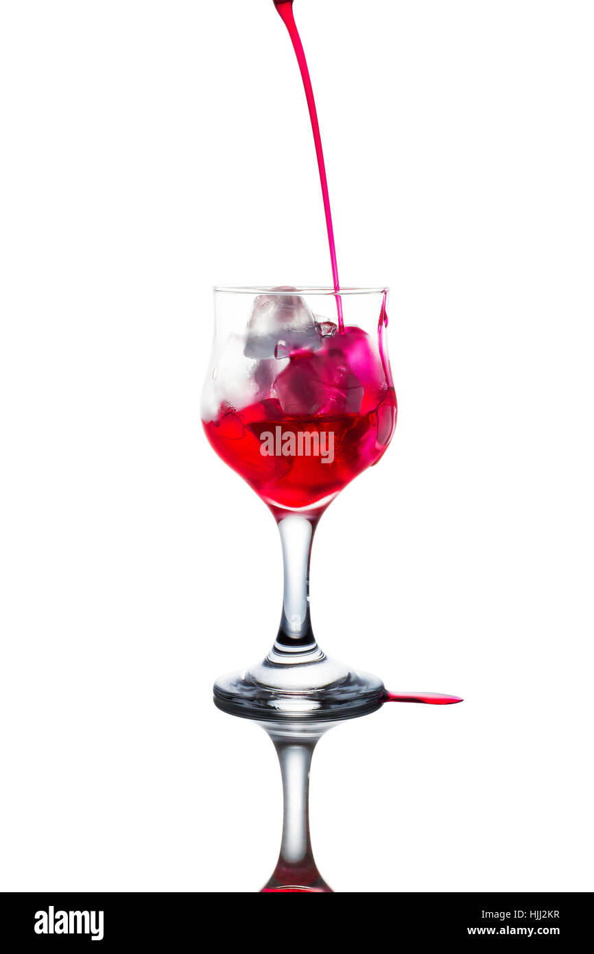 Pouring red syrup on ice with white background Stock Photo - Alamy