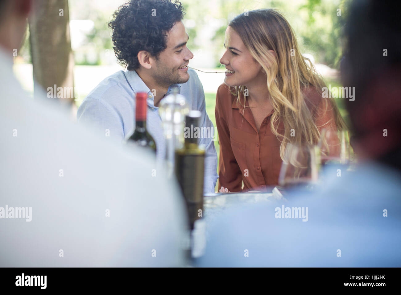 Couple sharing spaghetti at outdoor table Stock Photo - Alamy