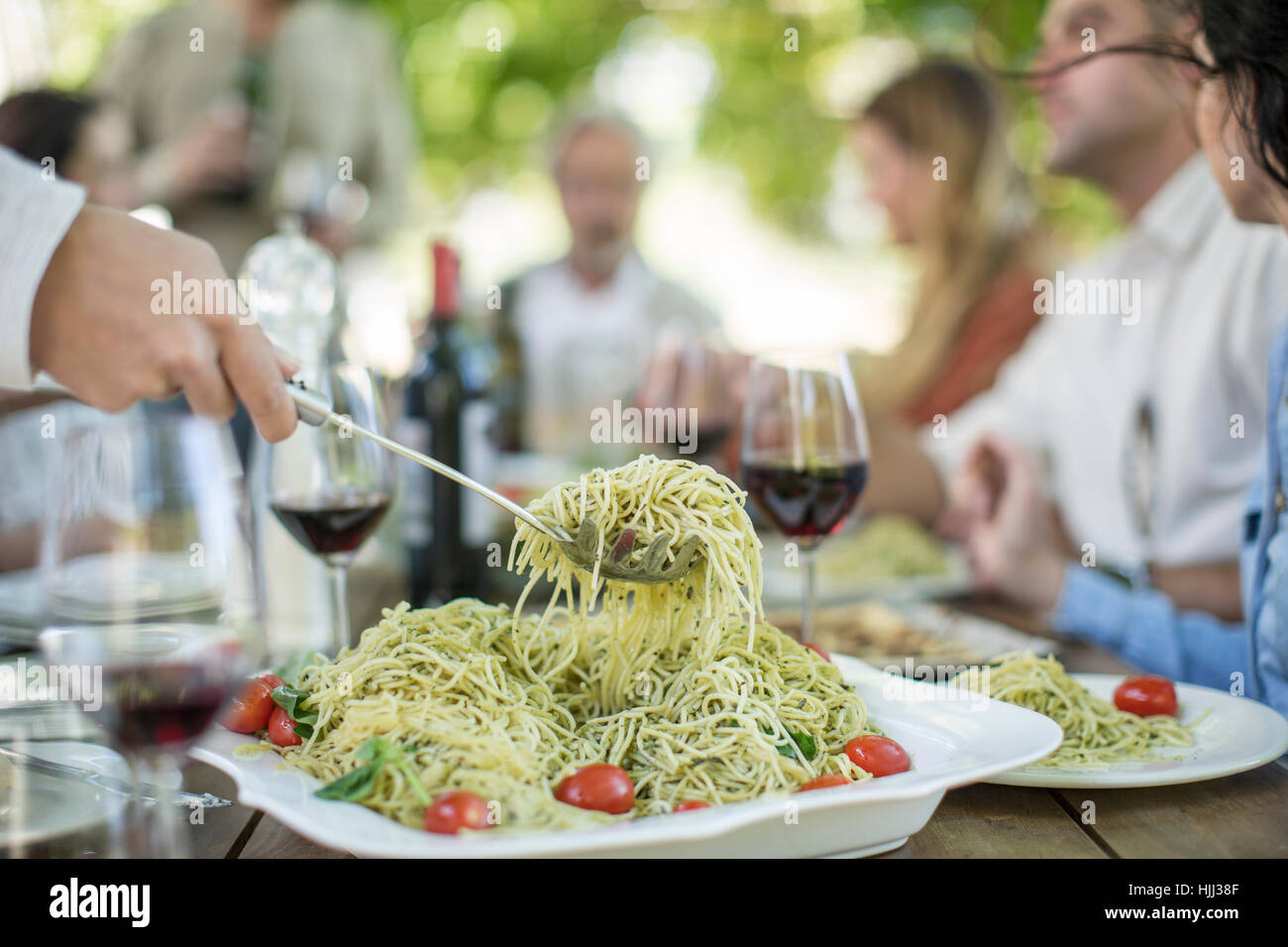 Eating spaghetti for lunch in garden Stock Photo - Alamy