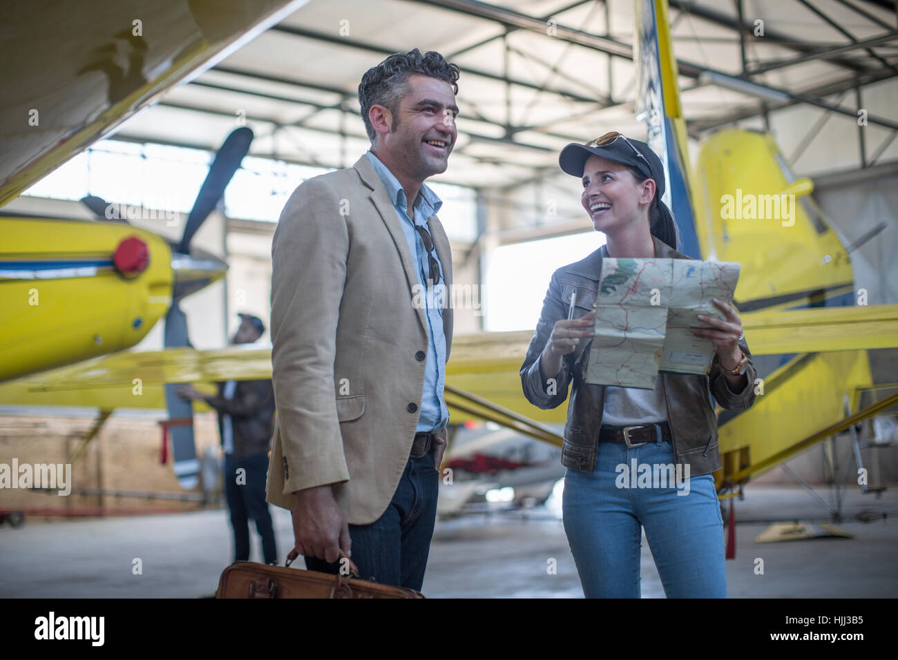 Female pilot talking to business client Stock Photo - Alamy