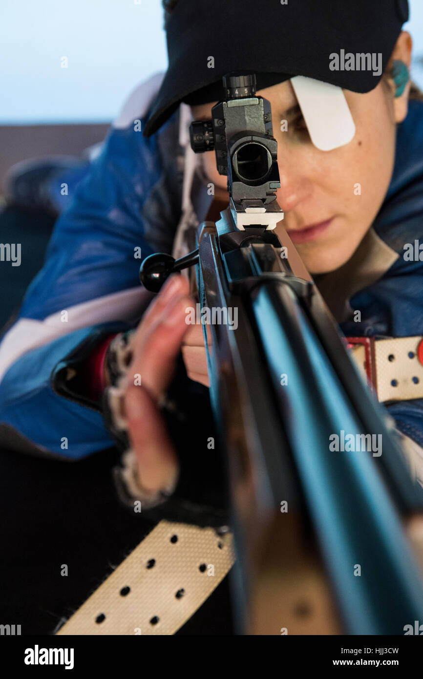 Woman with a sporting rifle aiming in a shooting range Stock Photo - Alamy