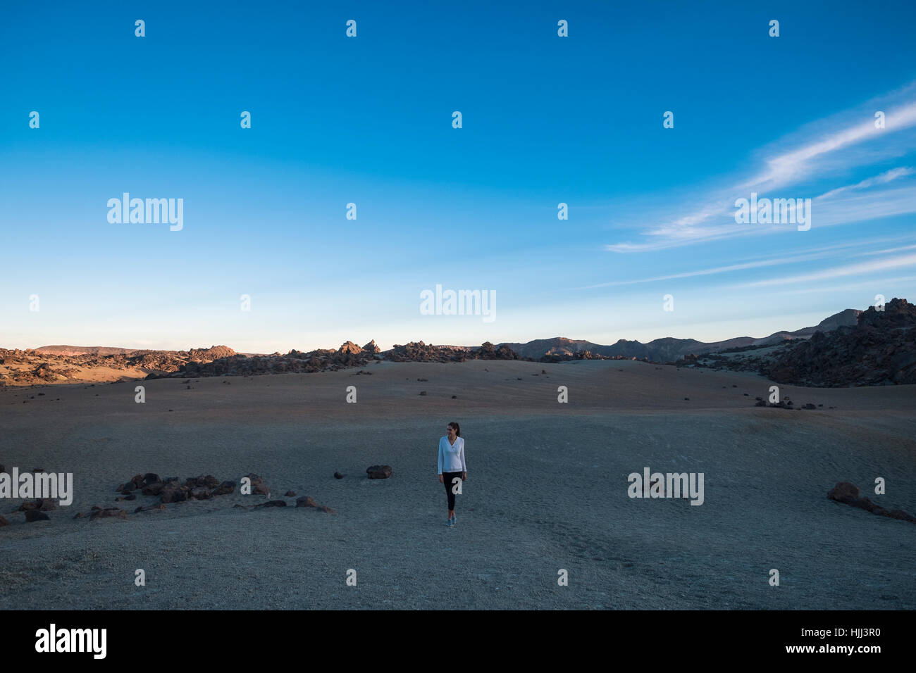 Young woman taking a walk in desert Stock Photo - Alamy
