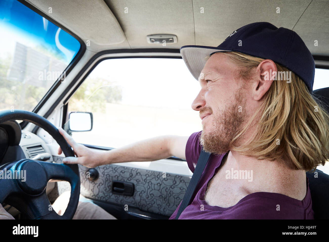 Blond man driving car Stock Photo - Alamy