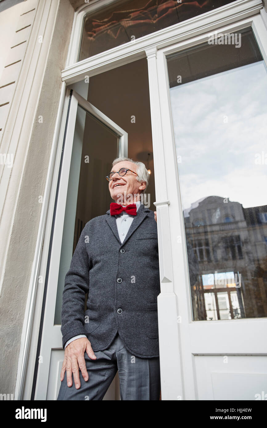 Smiling senior man at the window Stock Photo - Alamy