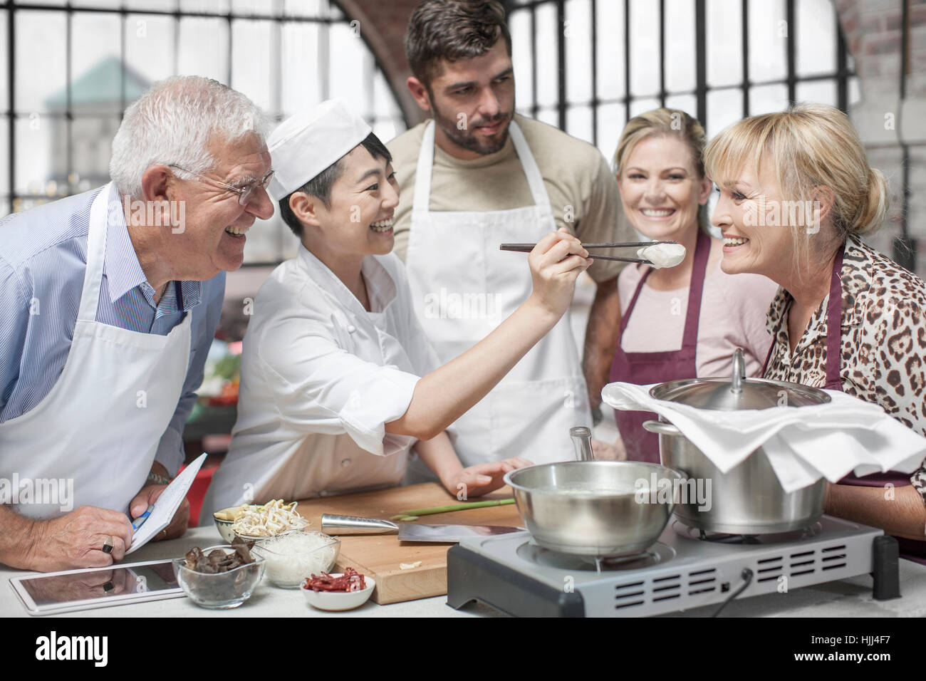 Group of people taking cooking course Stock Photo - Alamy