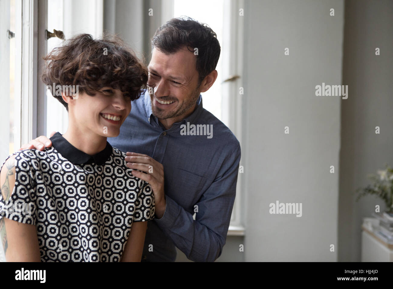 Laughing couple at home Stock Photo - Alamy