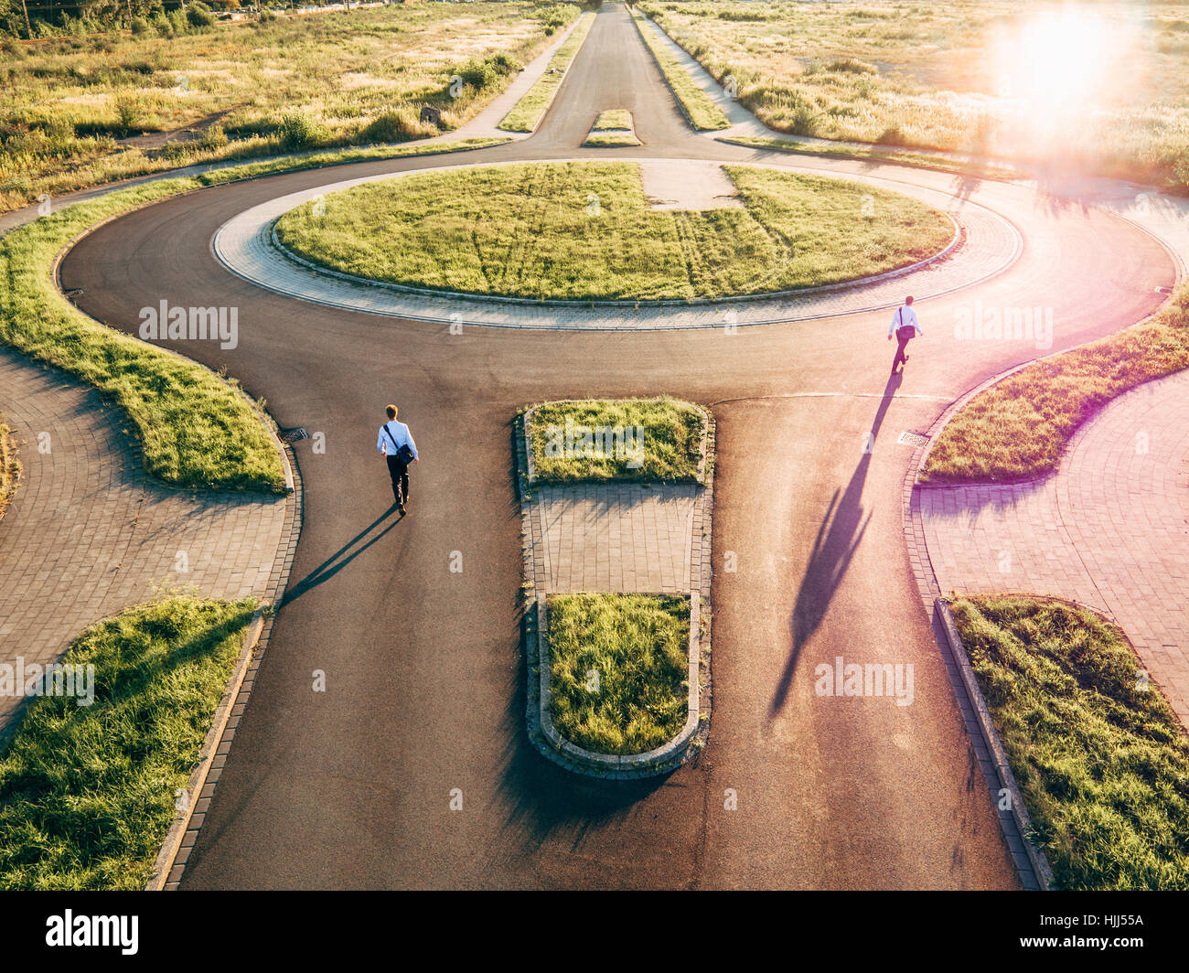 Two businessmen walking in roundabout Stock Photo - Alamy