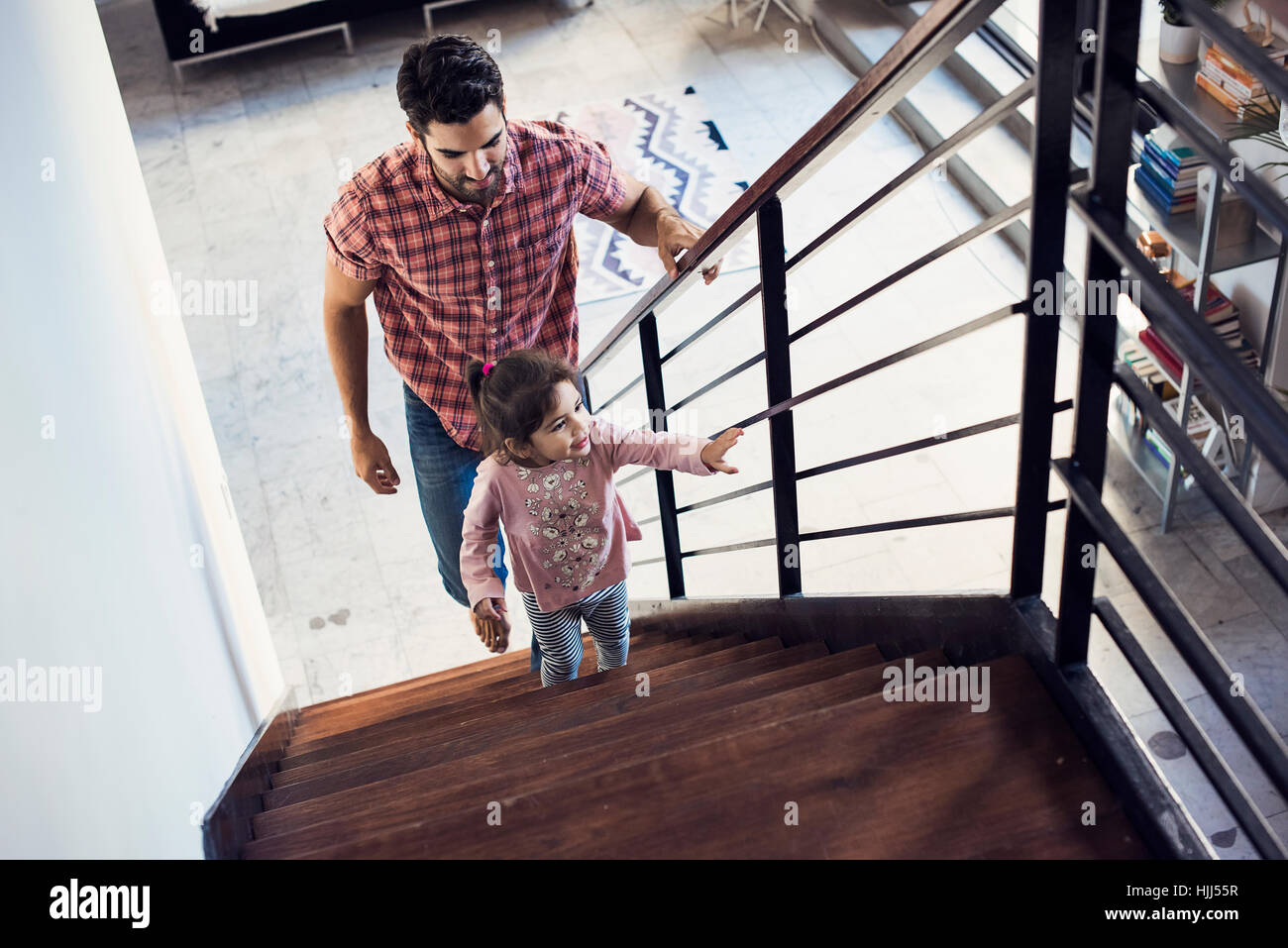 Father and daughter climbing stairs Stock Photo - Alamy