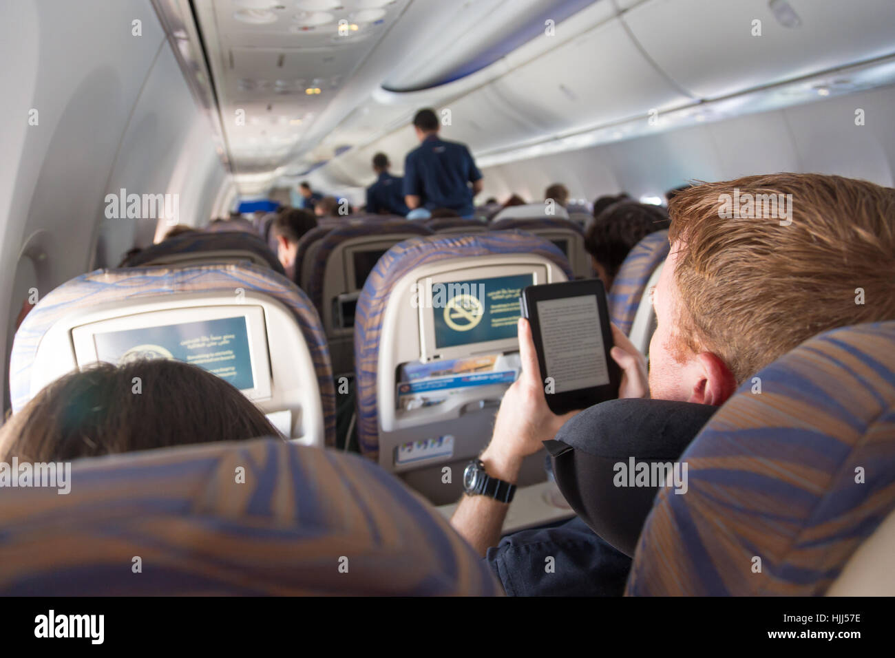 Passenger airplane reading book stewardess hi-res stock photography and ...
