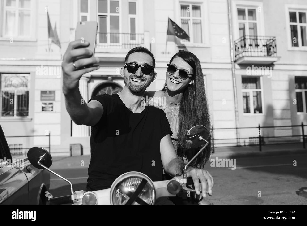 Cute couple make selfie on a scooter Stock Photo - Alamy