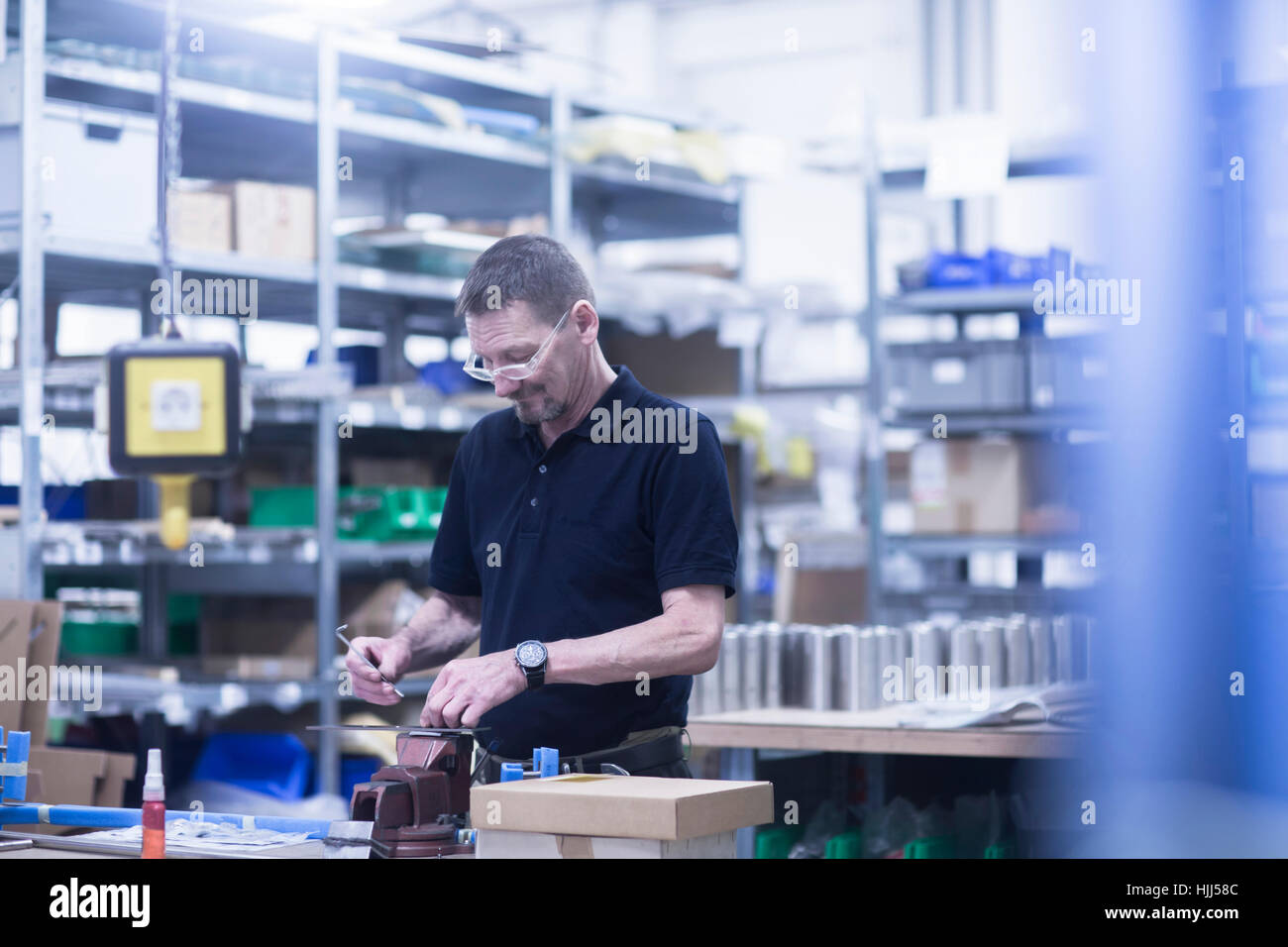 Man at work in a factory Stock Photo - Alamy