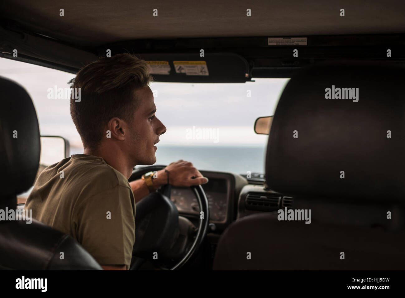 Young man driving car Stock Photo - Alamy