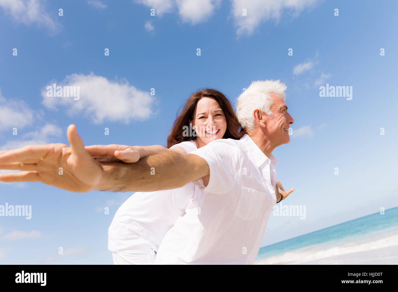 Couple having fun on the beach Stock Photo - Alamy