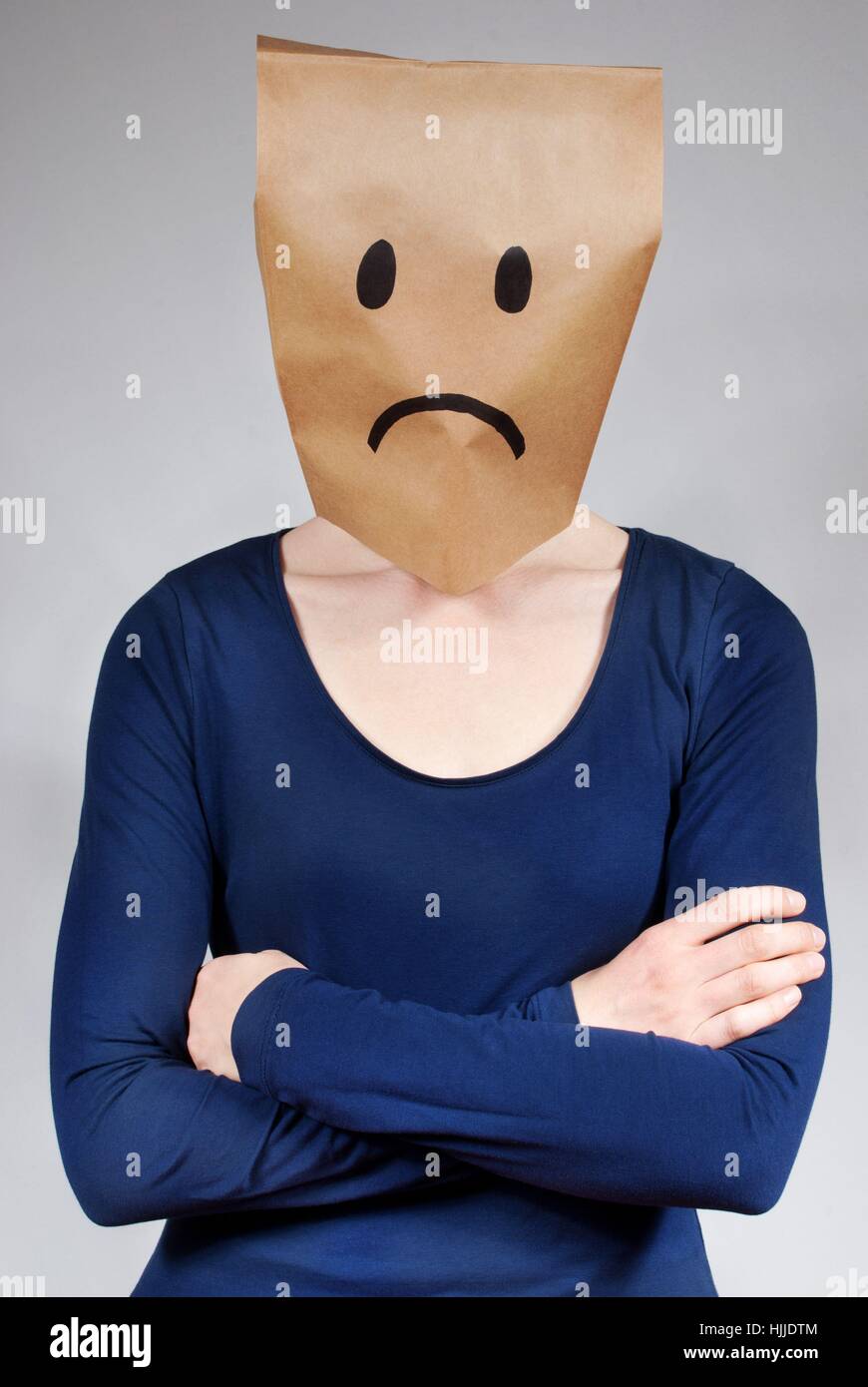 a sad and depressed looking person on gray background Stock Photo - Alamy
