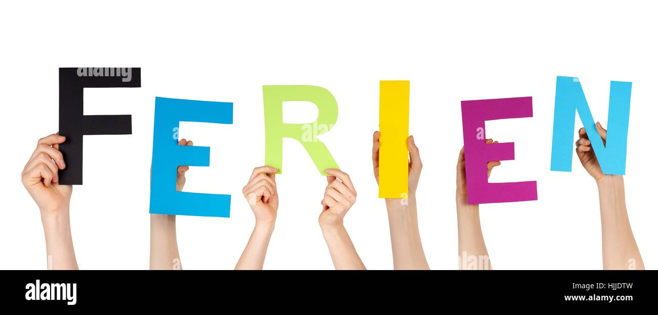 hands holding letters building the german word FERIEN, which means ...