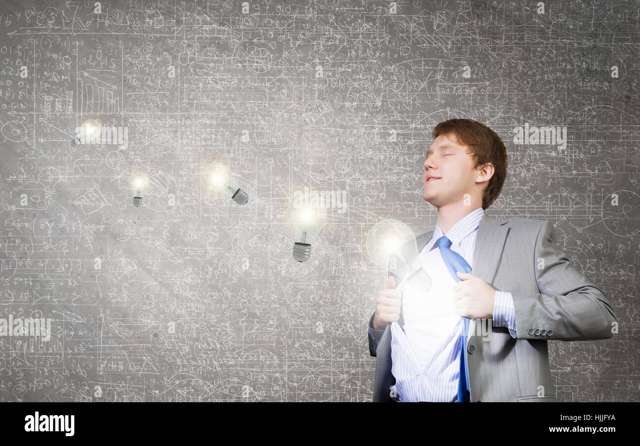 Young businessman opening chest and acting like super hero hi-res stock ...