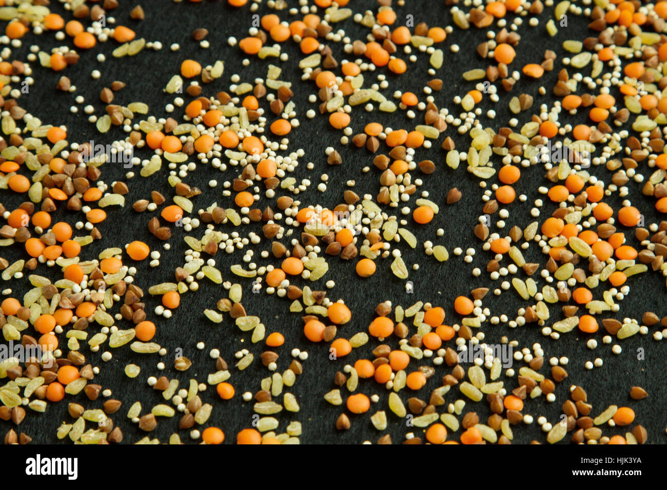 Four different groats: buckwheat, lentil, quinoa, bulgur on black ...