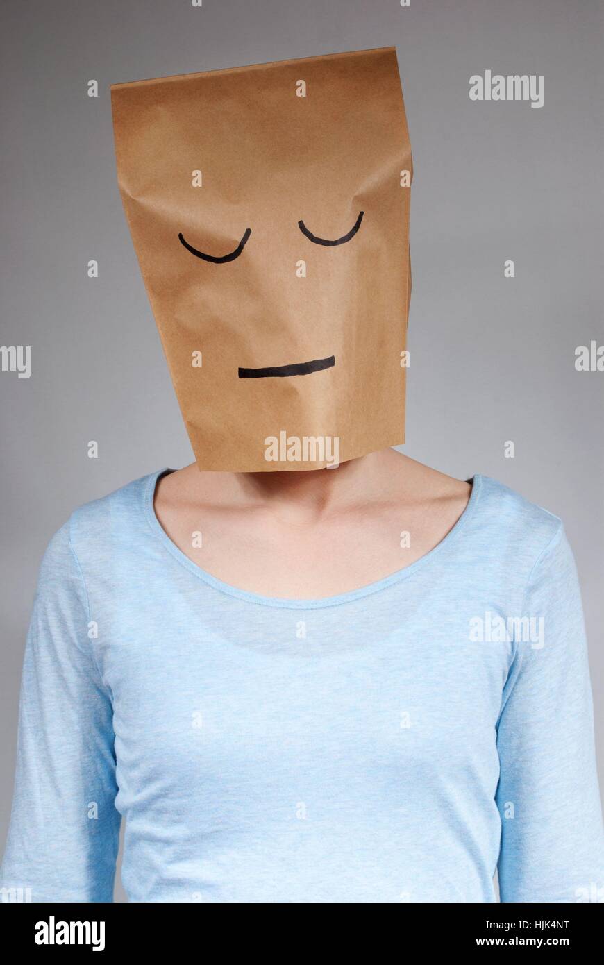 a sleeping or tired looking person with gray background Stock Photo - Alamy