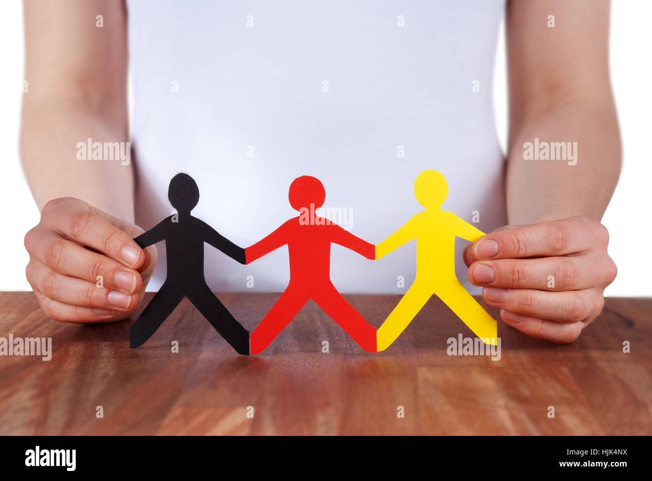 hand holds paper chain people in the color of germany, isolated Stock ...