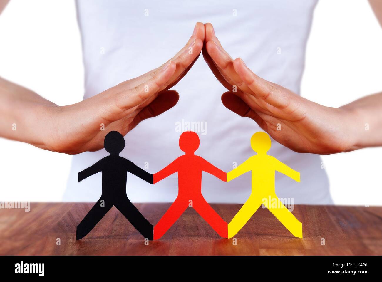 a hand forms a roof and symbolizes the protection of colorful paper ...