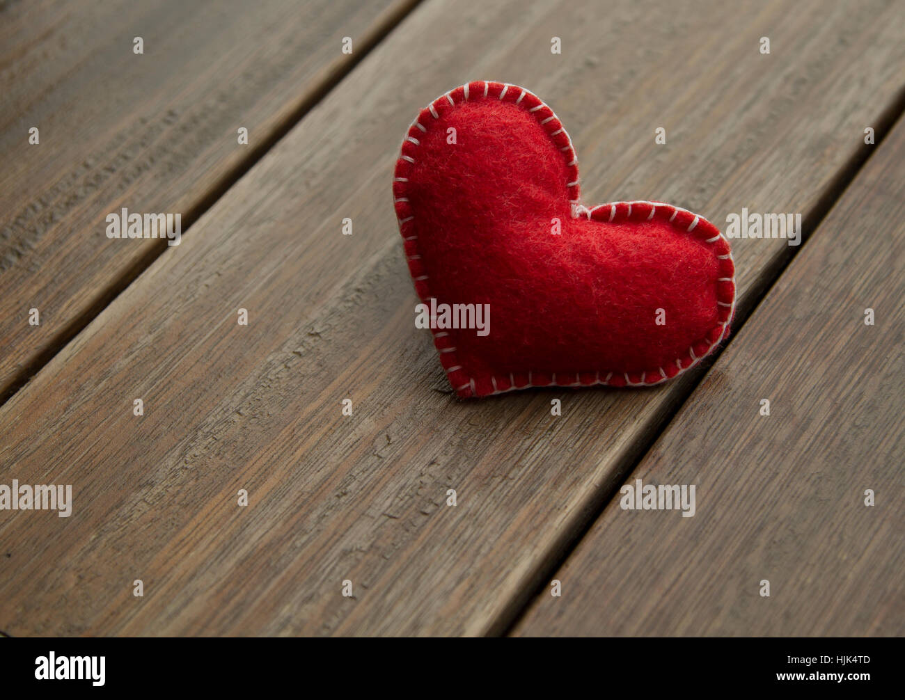Red textile heart on wood background, love concept Stock Photo - Alamy