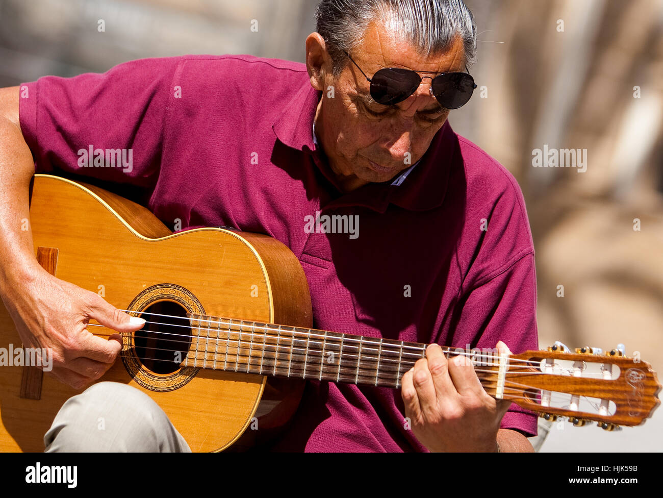 busker playing classical Spanish guitar in the square in front of Cadiz ...