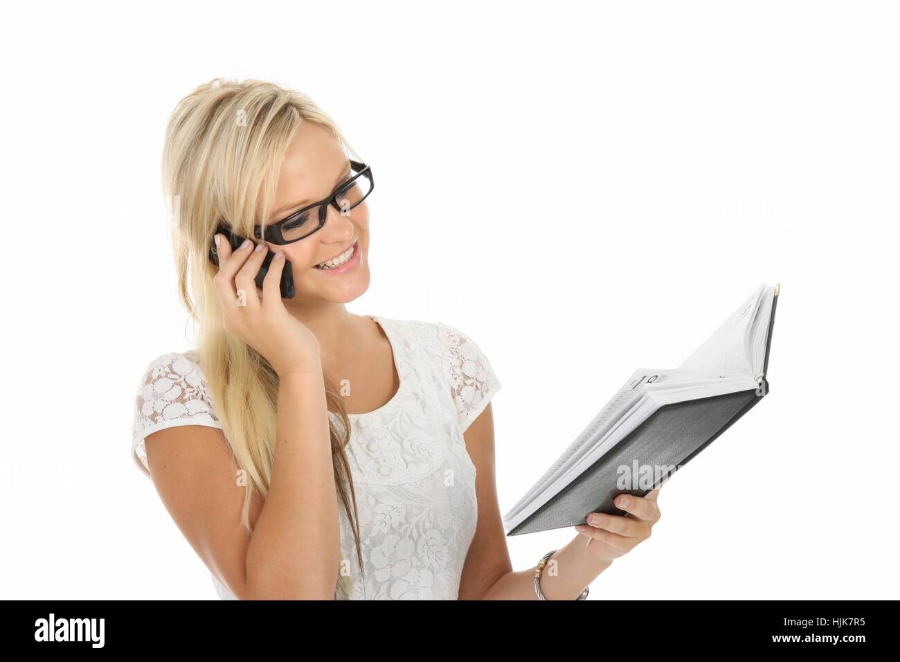 Beautiful young blond woman talking on mobile phone and checking her ...