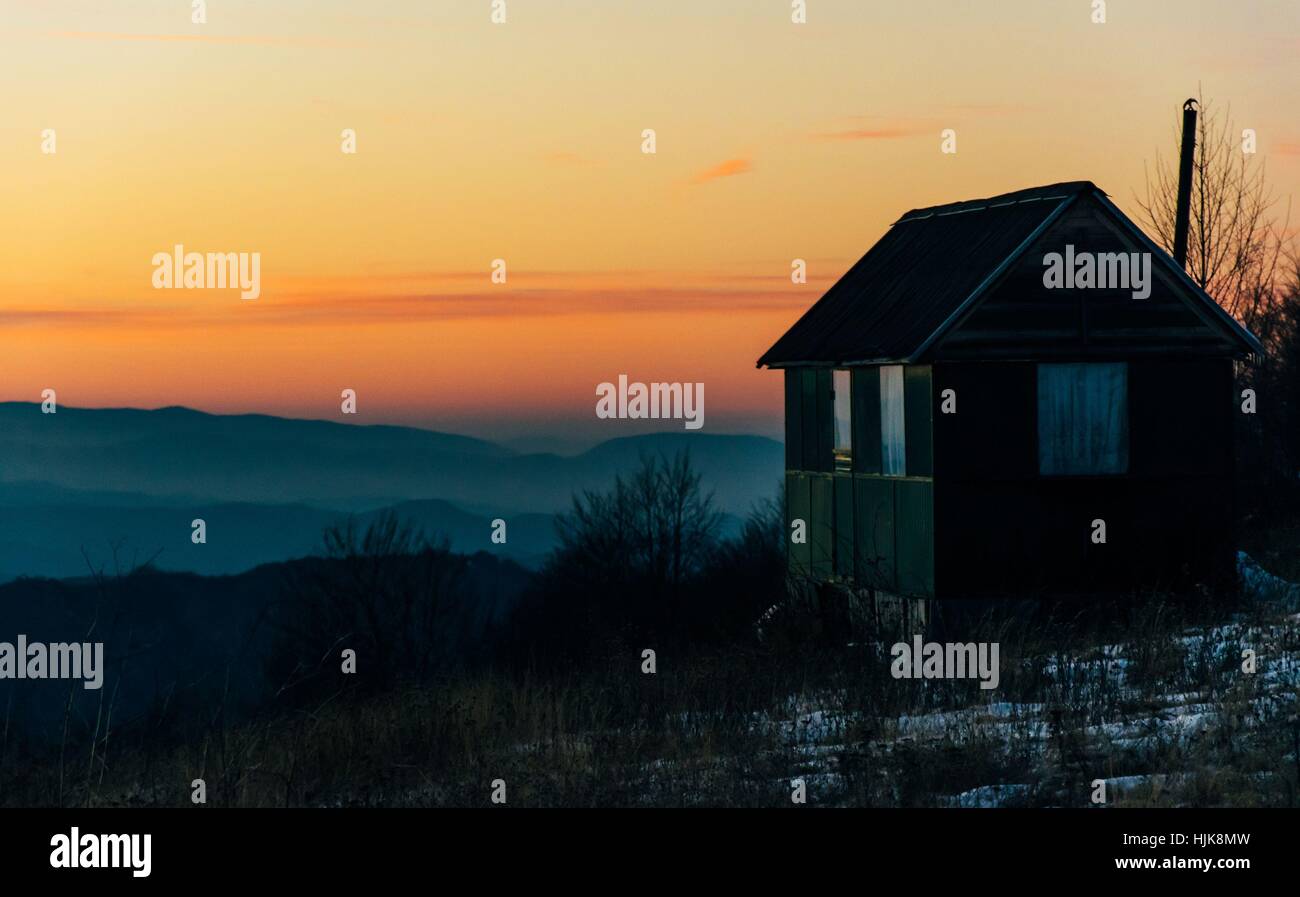 House in mountains with sunset Stock Photo - Alamy