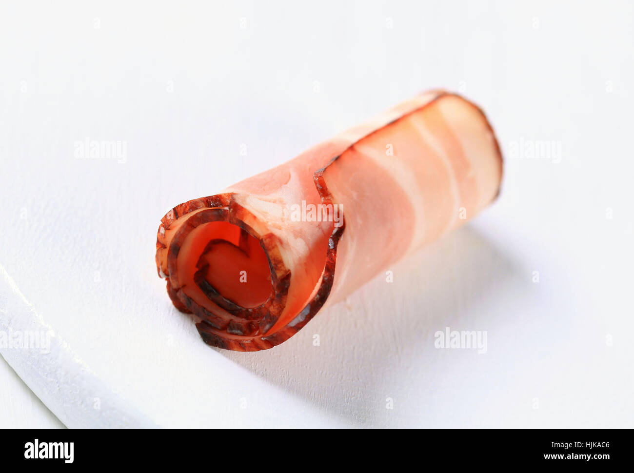 Slice of bacon, rolled up Stock Photo - Alamy