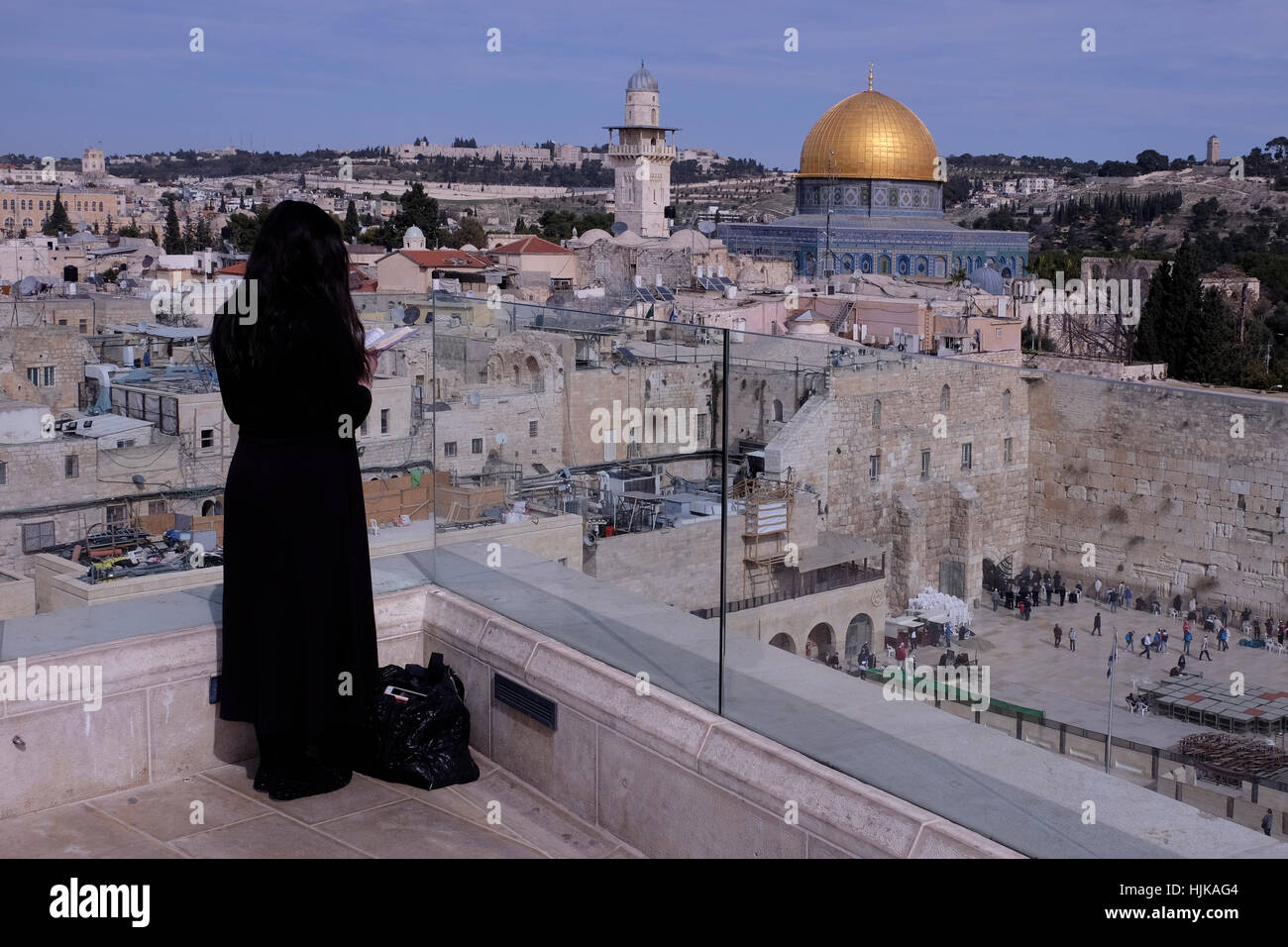 A religious Jewish woman praying on a roof in the Jewish quarter ...