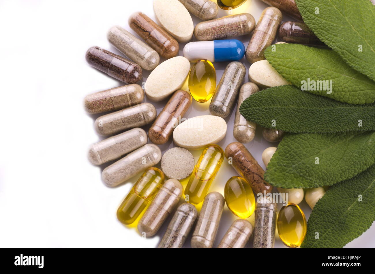 herbal capsules and herbal leaves isolated on white background Stock ...