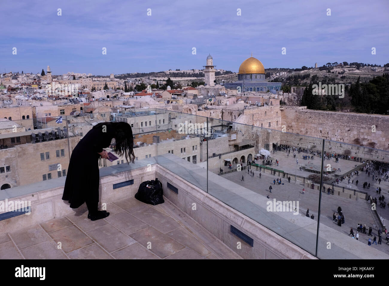 A religious Jewish woman praying on a roof in the Jewish quarter ...