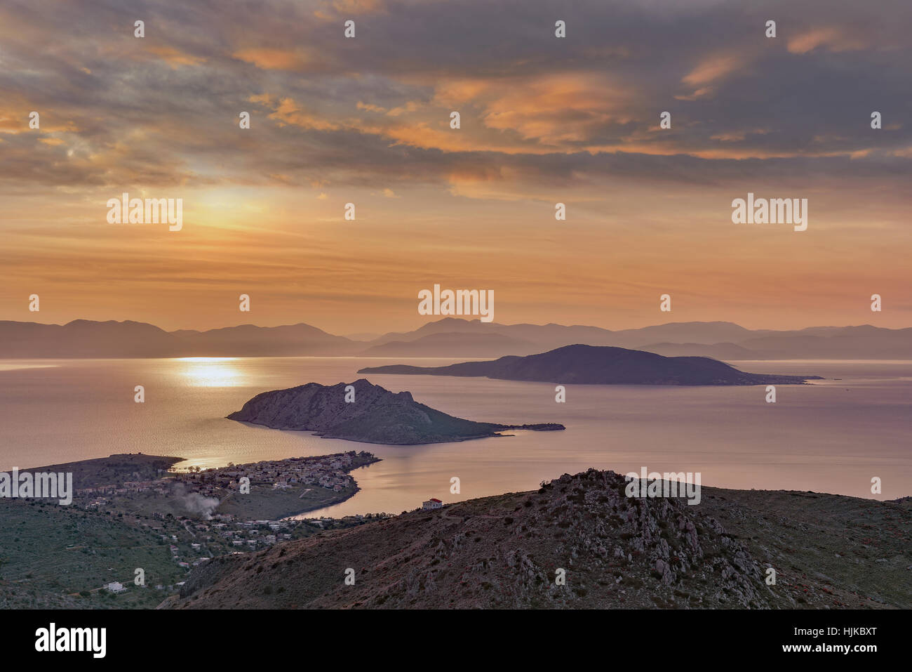 Sunset at Perdika village and Moni islet in the Aegina island located ...