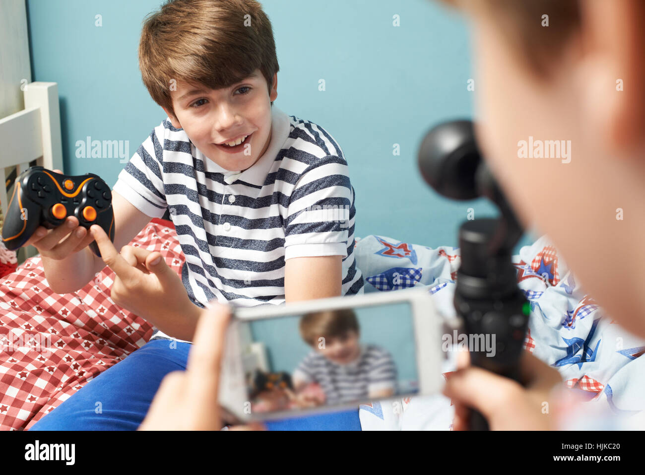 Two Boys Recording Gaming Blog In Bedroom Stock Photo - Alamy