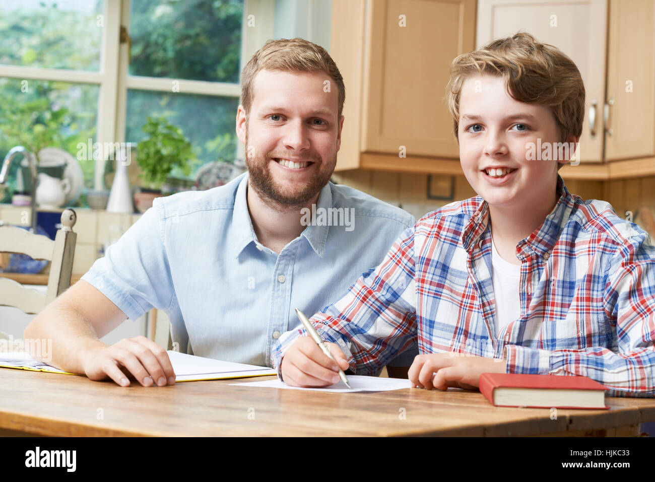 Male Home Tutor Helping Teenage Boy With Studies Stock Photo - Alamy